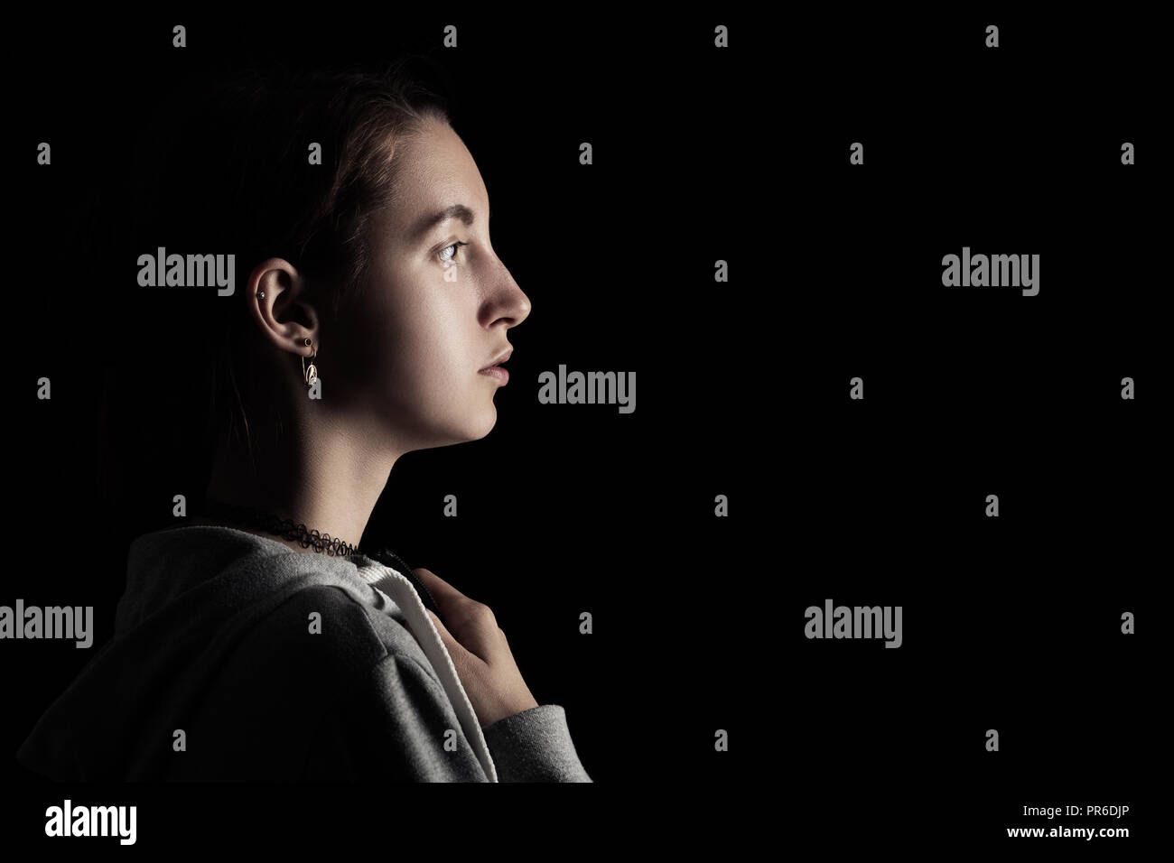 sad young female profile on black background with copy space Stock ...