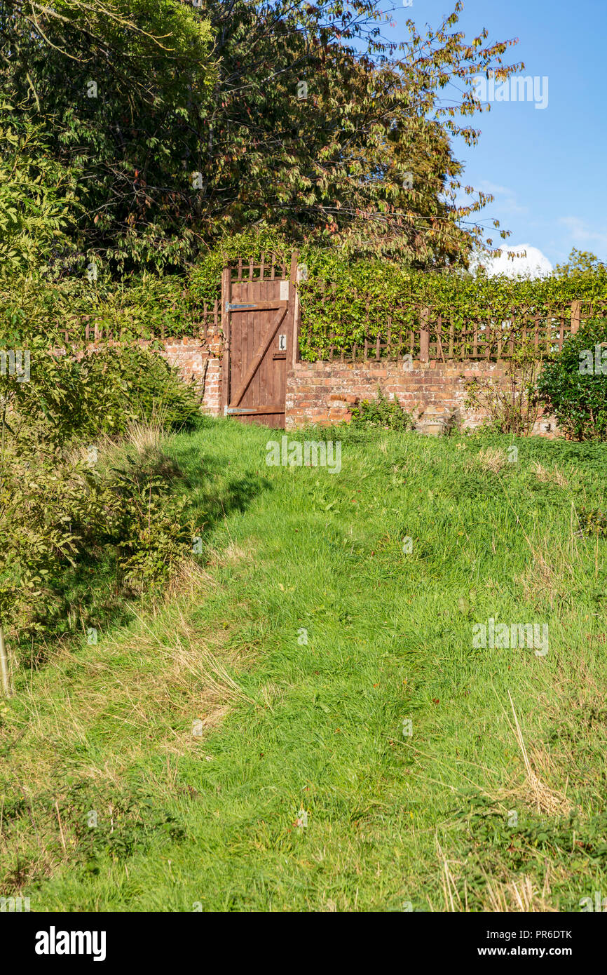 Red brick garden wall with red gate hi-res stock photography and images ...