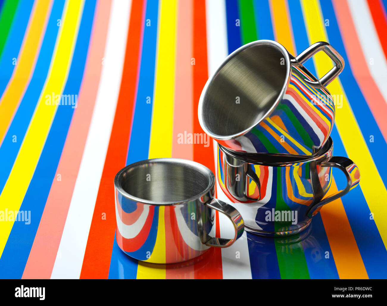 Metallic cups reflecting a colorful striped background Stock Photo - Alamy