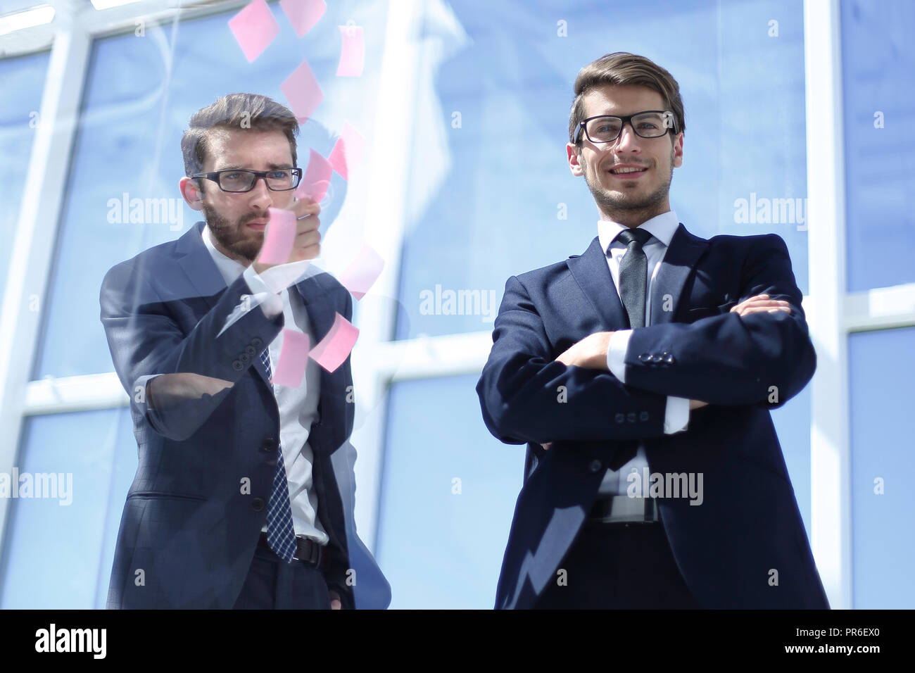 employee reading the stickers pasted on the glass wall Stock Photo - Alamy