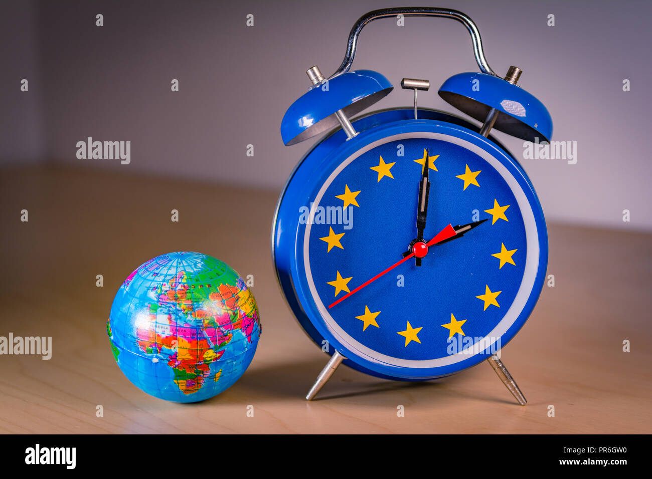 Retro alarm clock with the colors of the EU flag for an hour and planet ...
