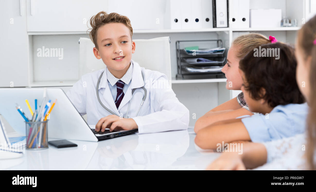 Medical brother boy in medical center with stethoscope with visitors ...