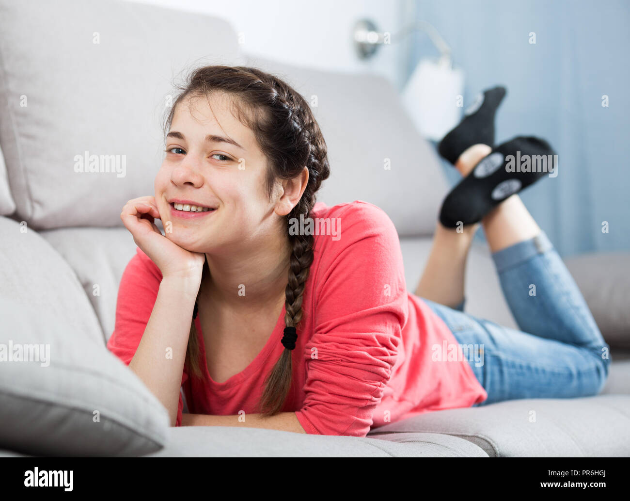 Smiling teenager using various poses having good time in leisure time ...