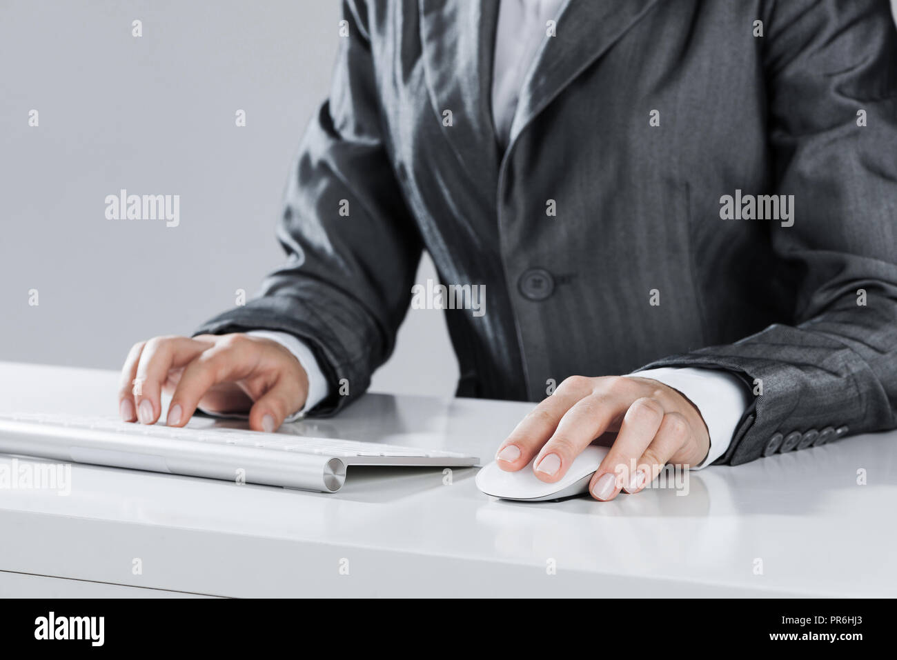 Closeup of businesswoman hand typing on keyboard with mouse on w Stock ...