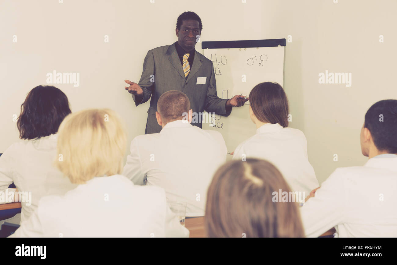 Smiling African American male professor giving presentation for medics ...