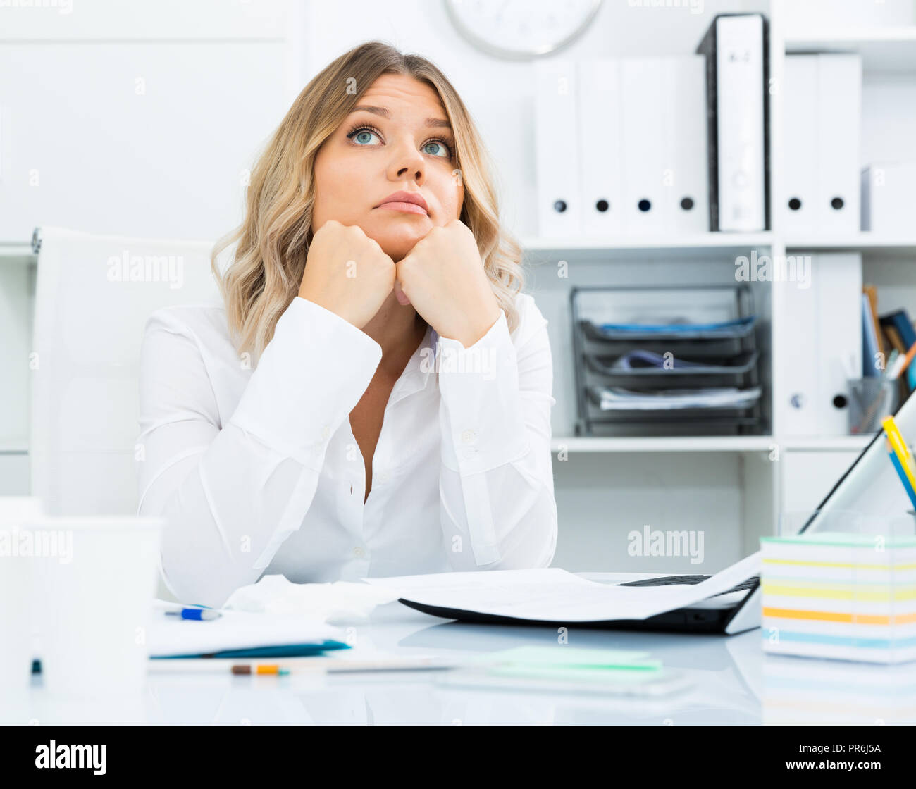Pensive young girl in business clothes in modern office Stock Photo - Alamy