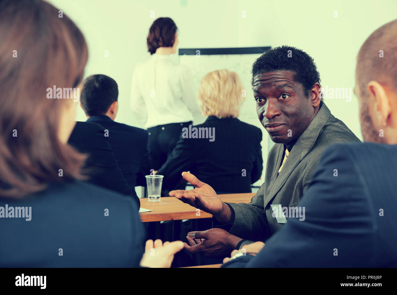 African American business man talking with people during conference in ...