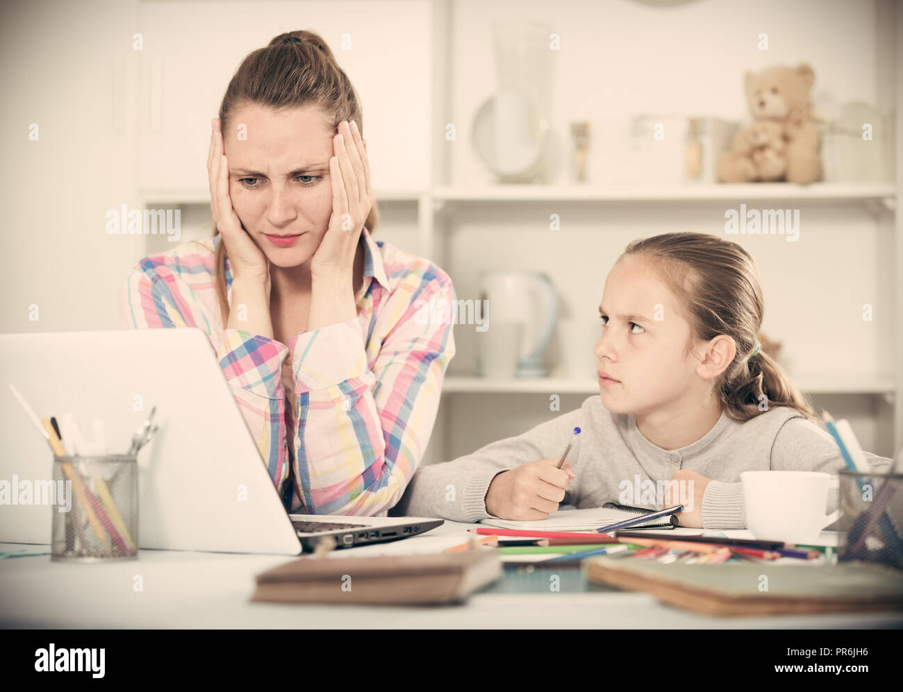 Irritated mother watching at the mistakes her daughter's homework Stock ...