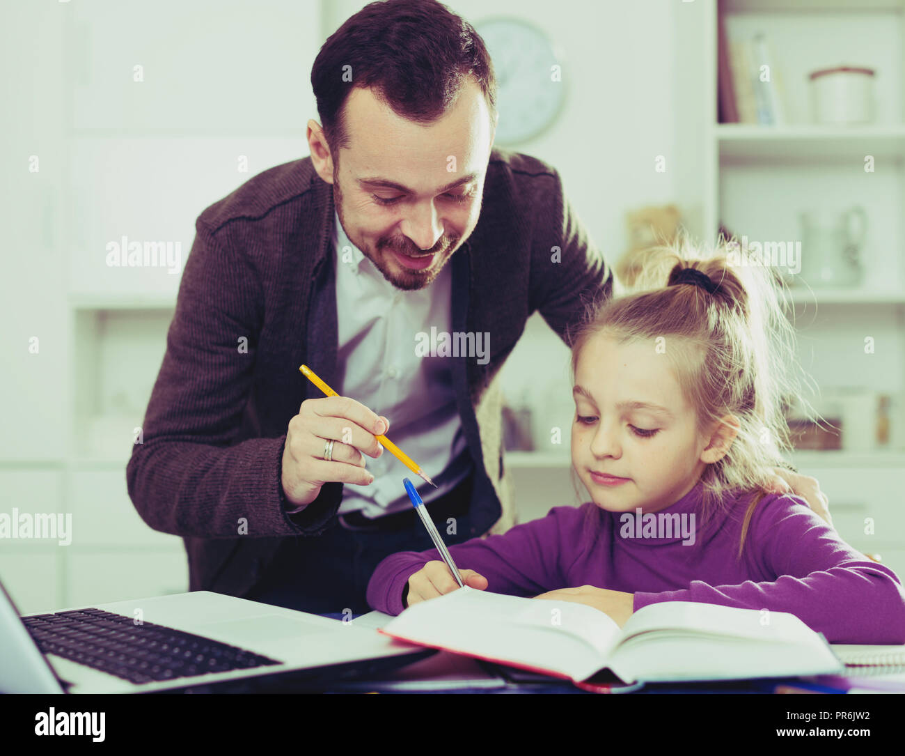 Father helping his child to do homework at home Stock Photo - Alamy