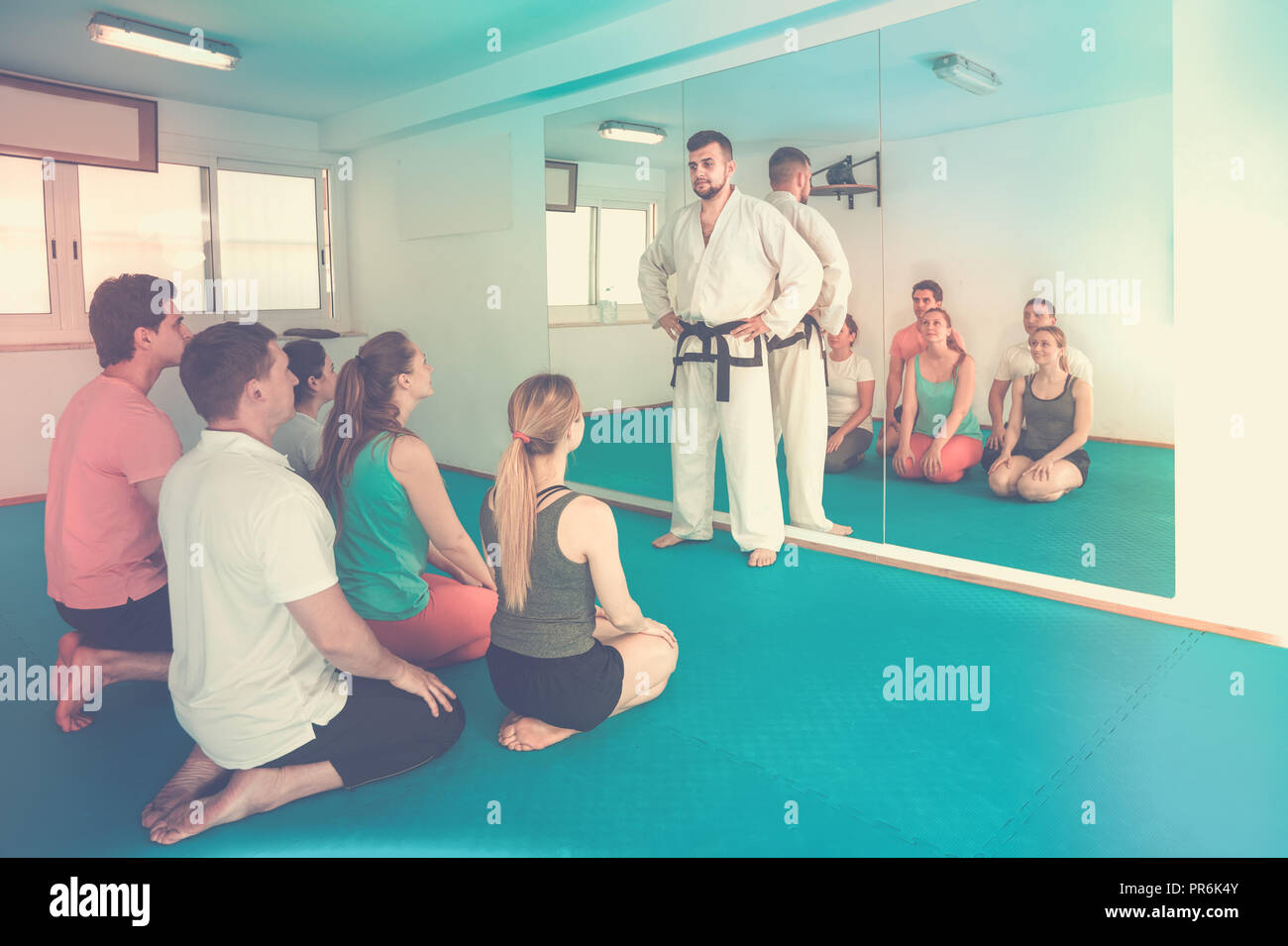 Adults enjoying their trainings with coach at karate class Stock Photo ...
