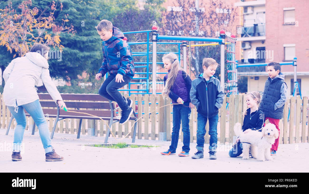 smiling russian children playing rubber band jumping game and laughing ...