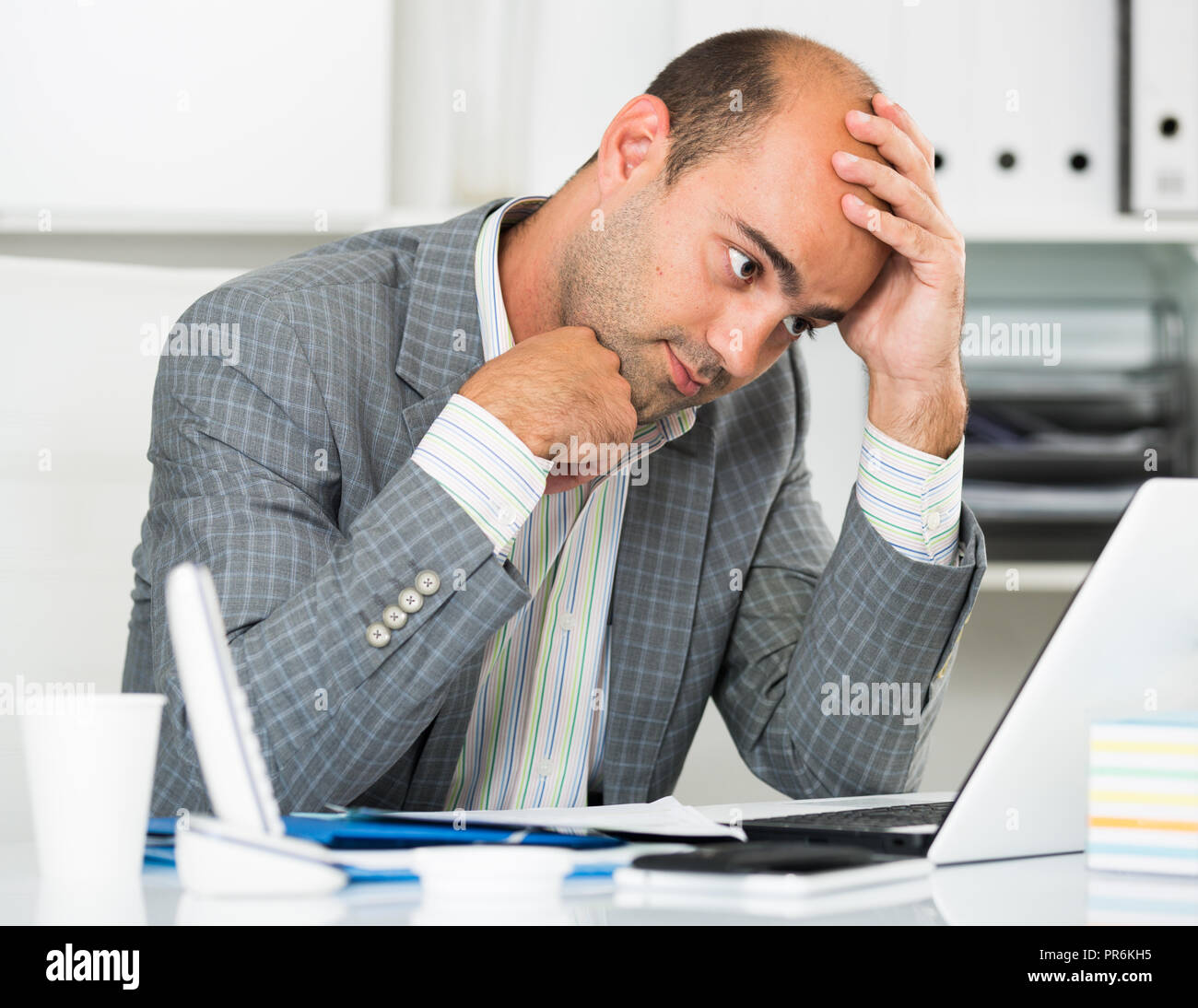 Male having lot of work and problems in the office Stock Photo - Alamy