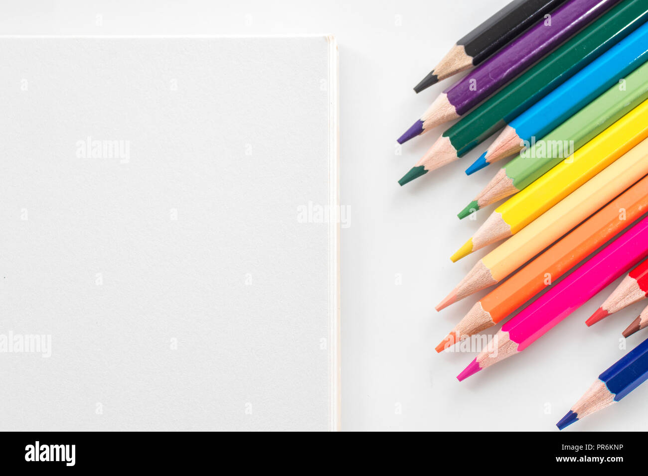 notepad with color pencil on white table view from above Stock Photo ...