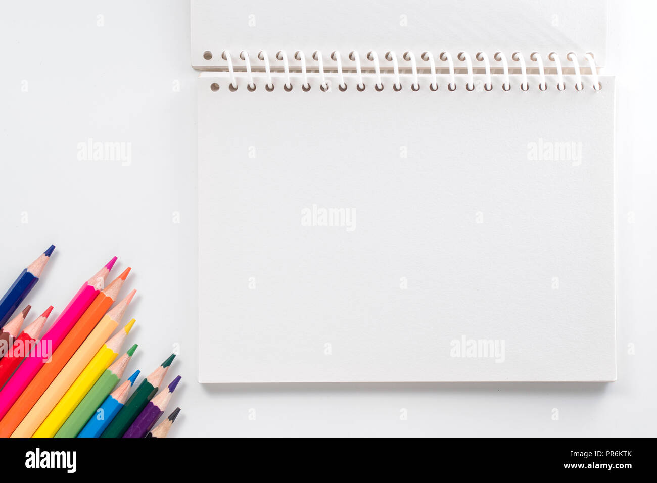 notepad with color pencil on white table view from above Stock Photo ...