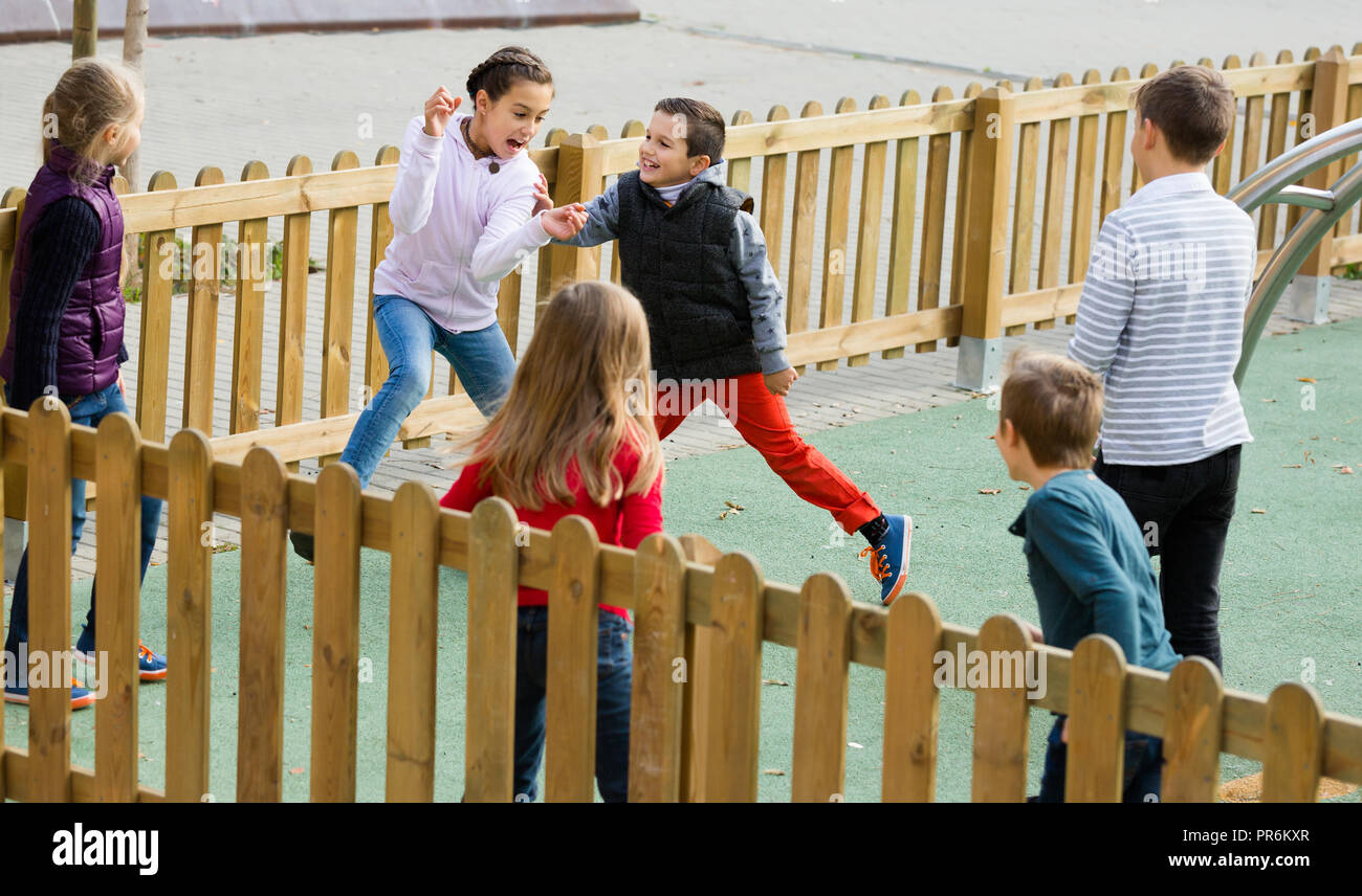 Smiling children playing romp game Touch-last at outdoor Stock Photo ...