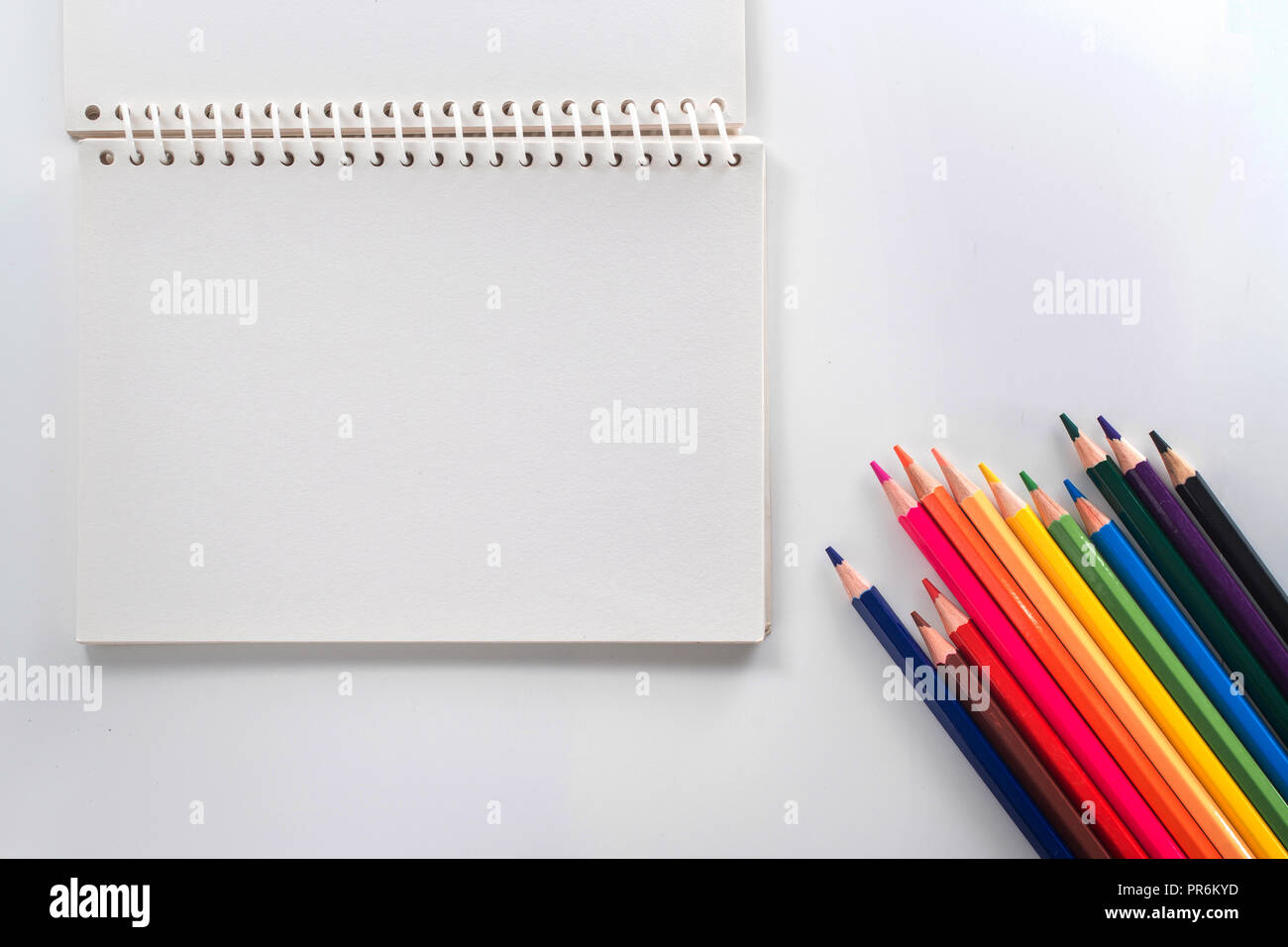 notepad with color pencil on white table view from above Stock Photo ...