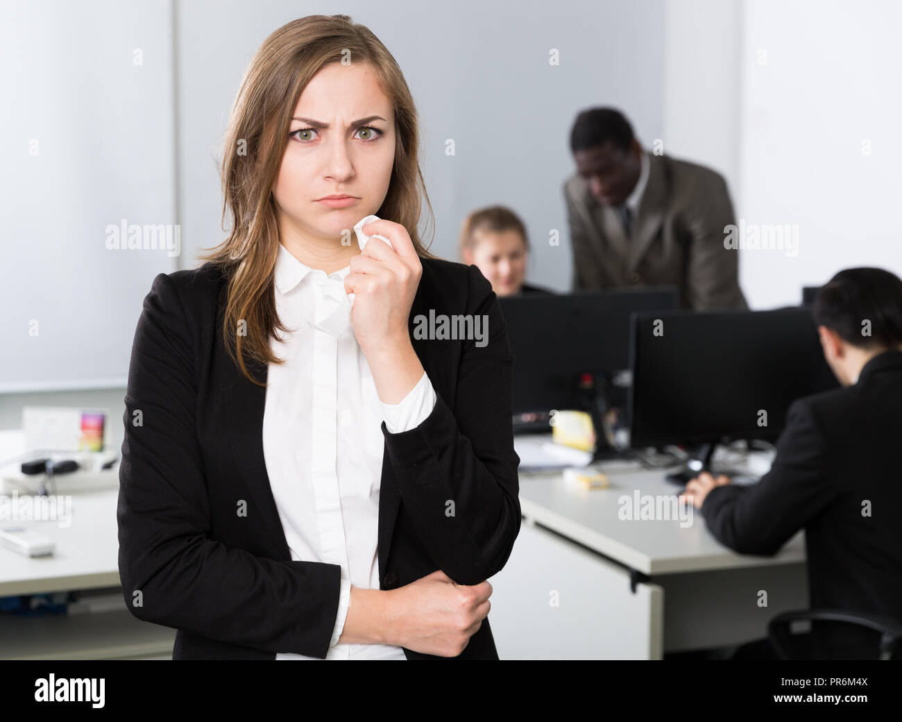 Portrait of frustrated young business woman in coworking space with ...