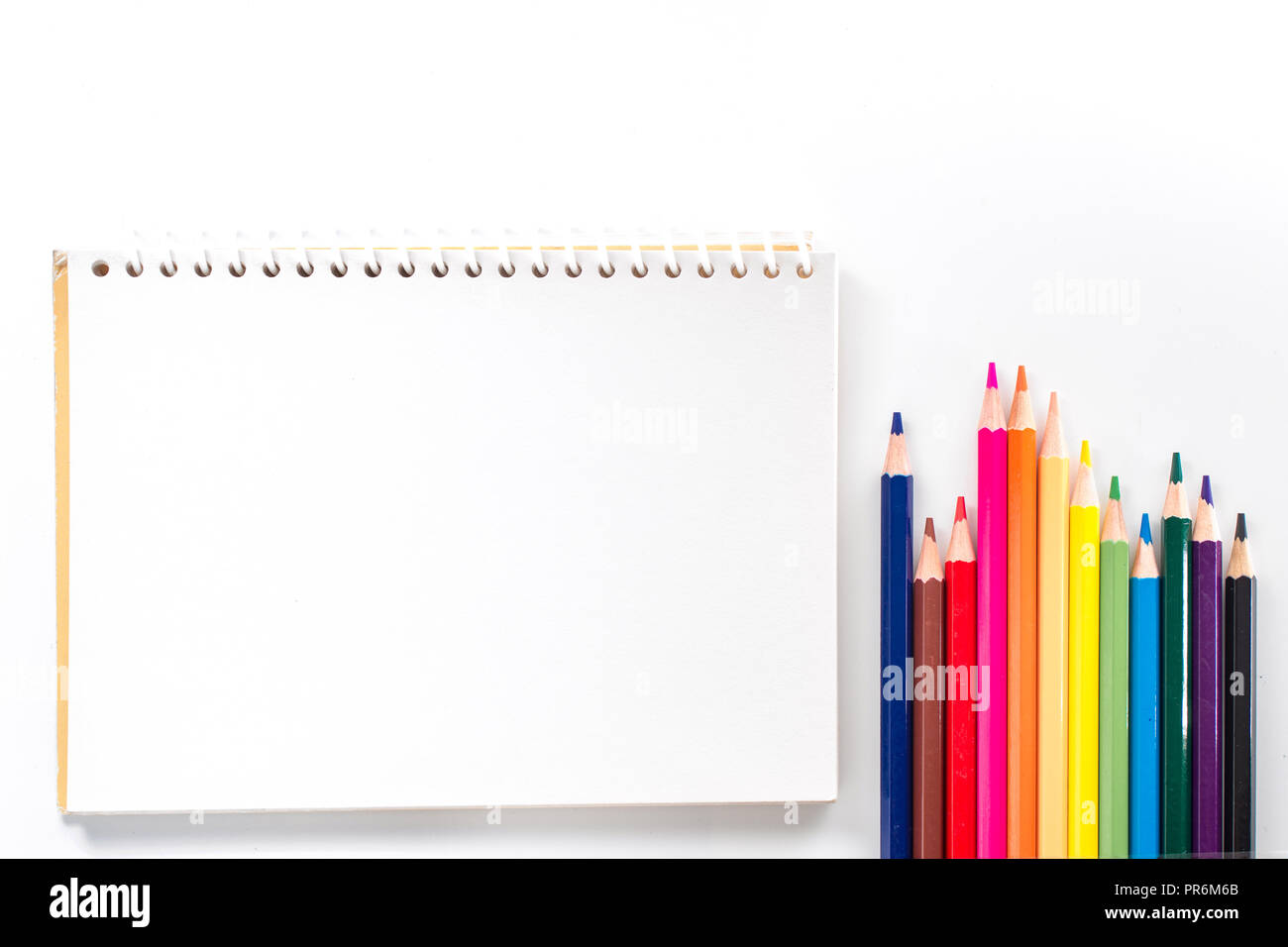 notepad with color pencil on white table view from above Stock Photo ...