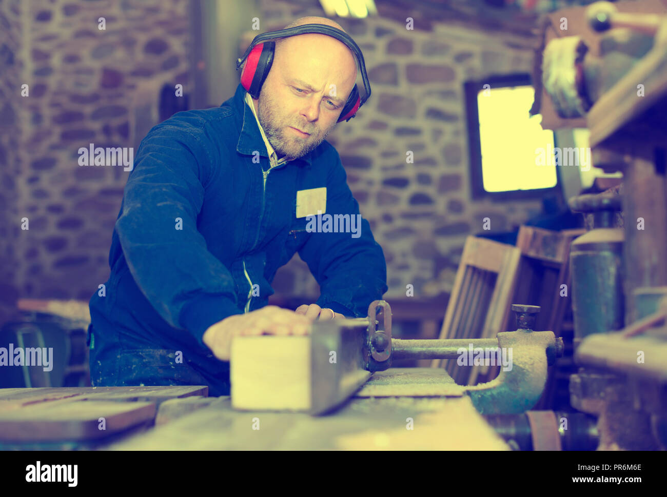 Portrait of professional woodworker is processing timber on a ...