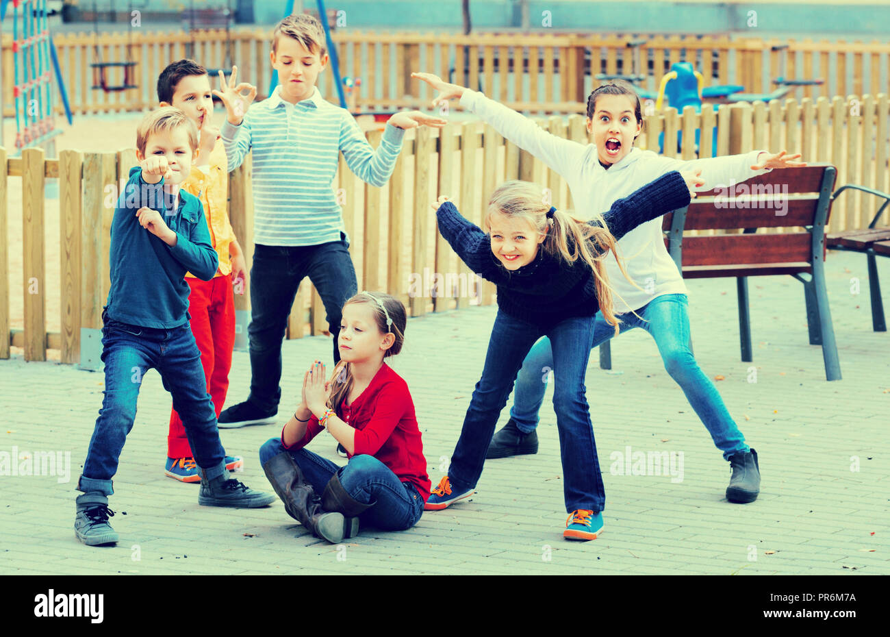Acting game with happy children making performance outdoor in autumn ...