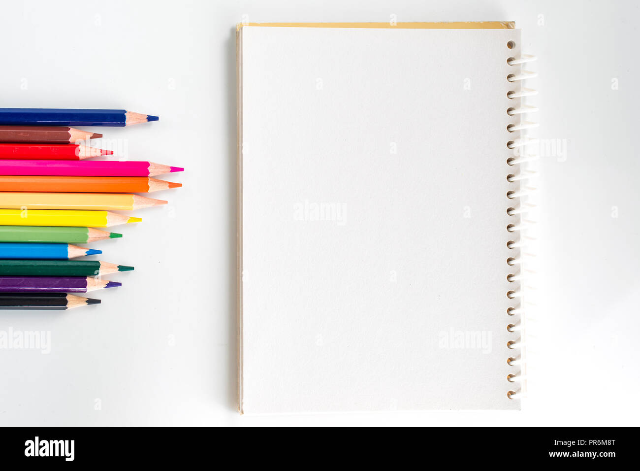 notepad with color pencil on white table view from above Stock Photo ...