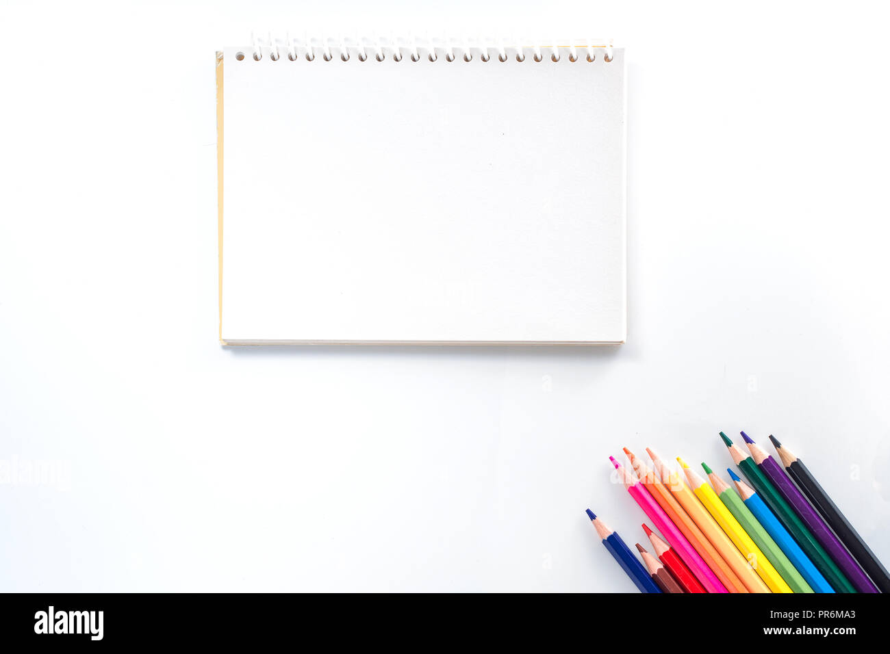 notepad with color pencil on white table view from above Stock Photo ...