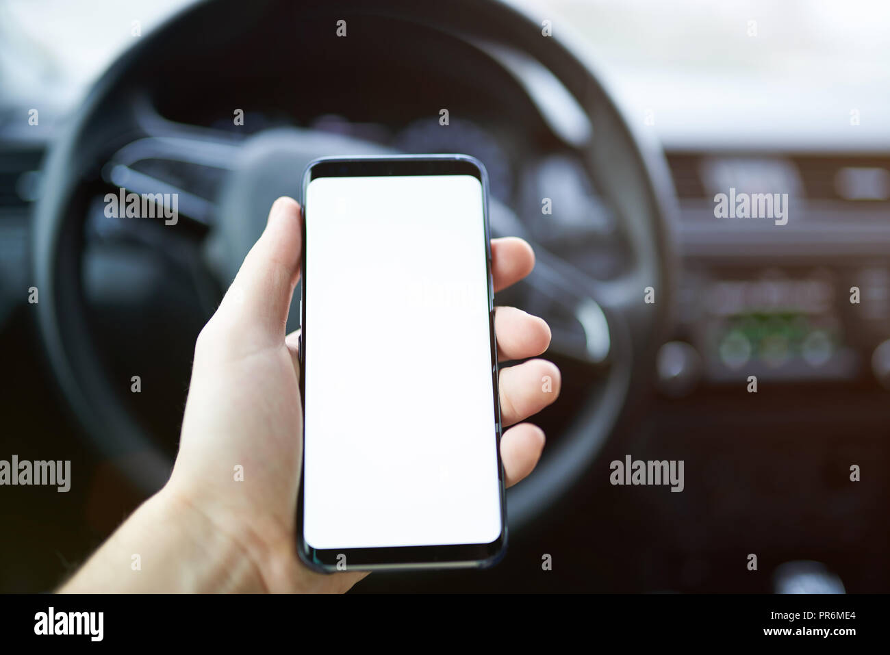 Smartphone in driver hand close-up. Mockup of phone in hand Stock Photo ...