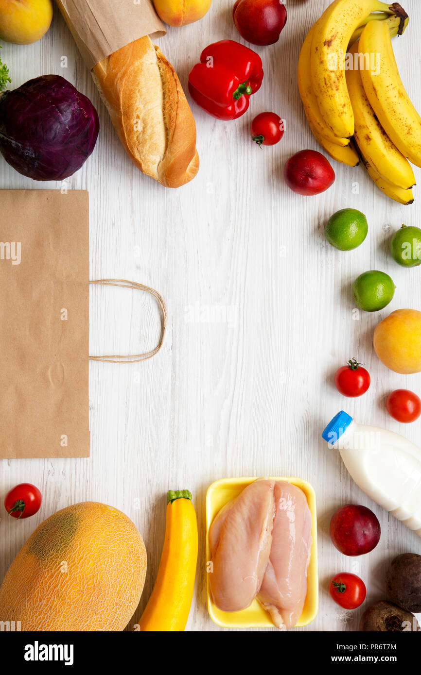 Healthy food and paper bag on white wooden table. Cooking food ...