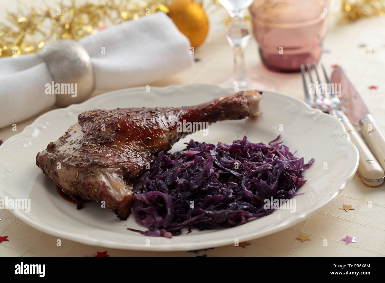 Roasted goose leg with braised red cabbage on a Christmas table Stock ...
