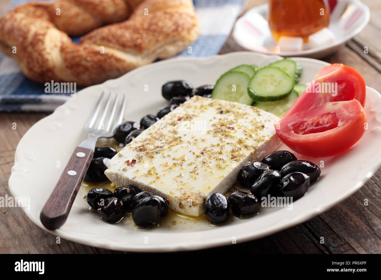 Breakfast with feta cheese, olives, simit, vegetables and tea Stock ...