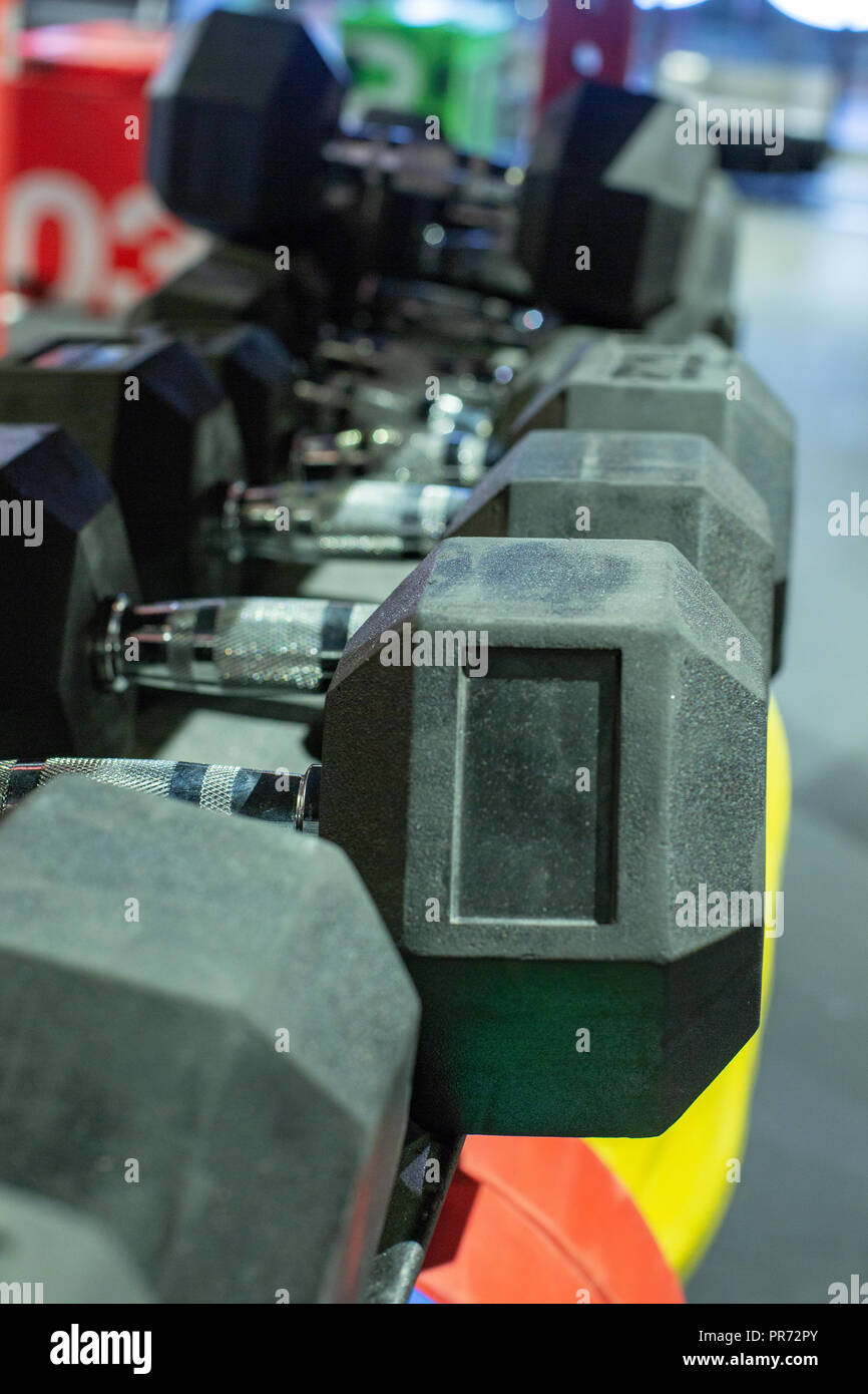 Black rubber dumbbells. Hexagonal heavy duty weight set used for ...