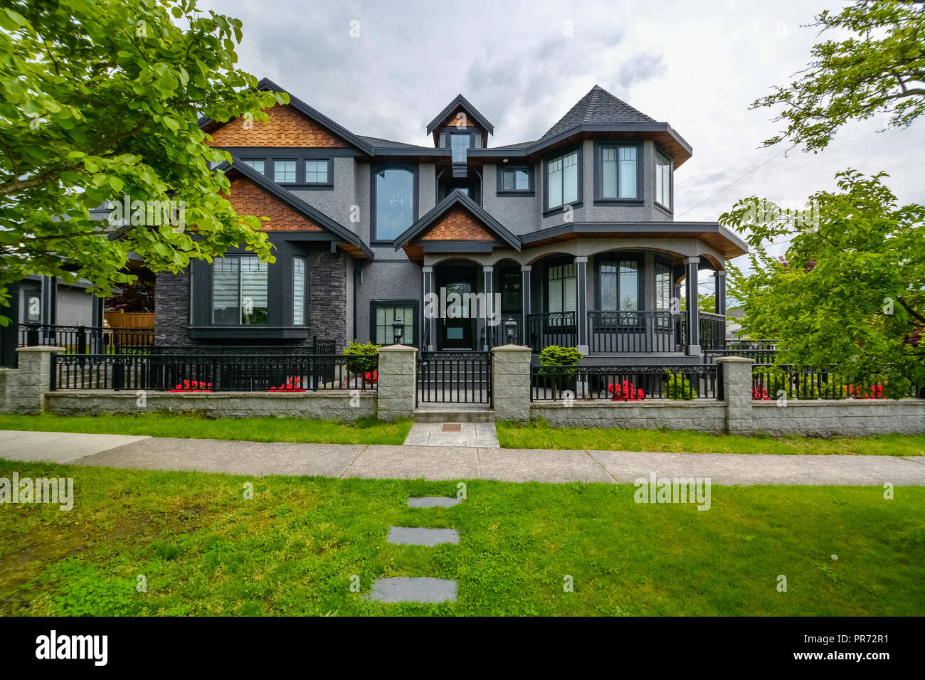Paved pathway to the entrance of residential house with metal grid gate ...