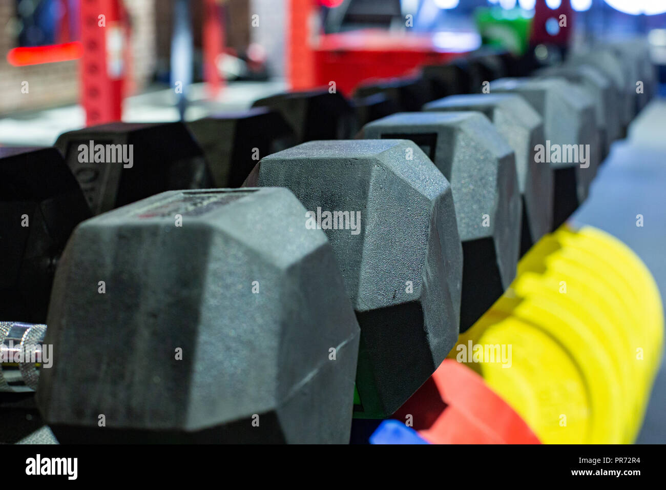 Black rubber dumbbells. Hexagonal heavy duty weight set used for ...