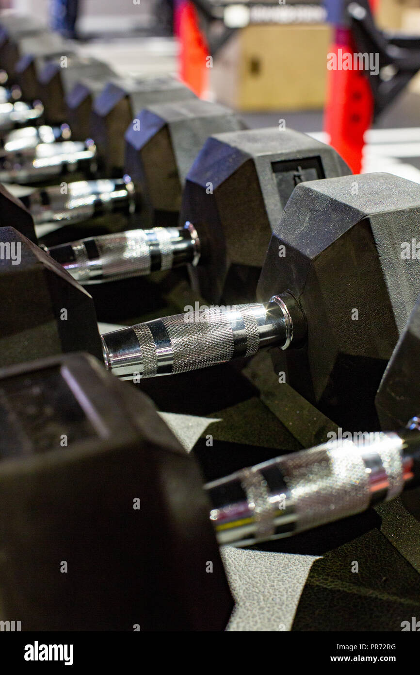 Black rubber dumbbells. Hexagonal heavy duty weight set used for ...