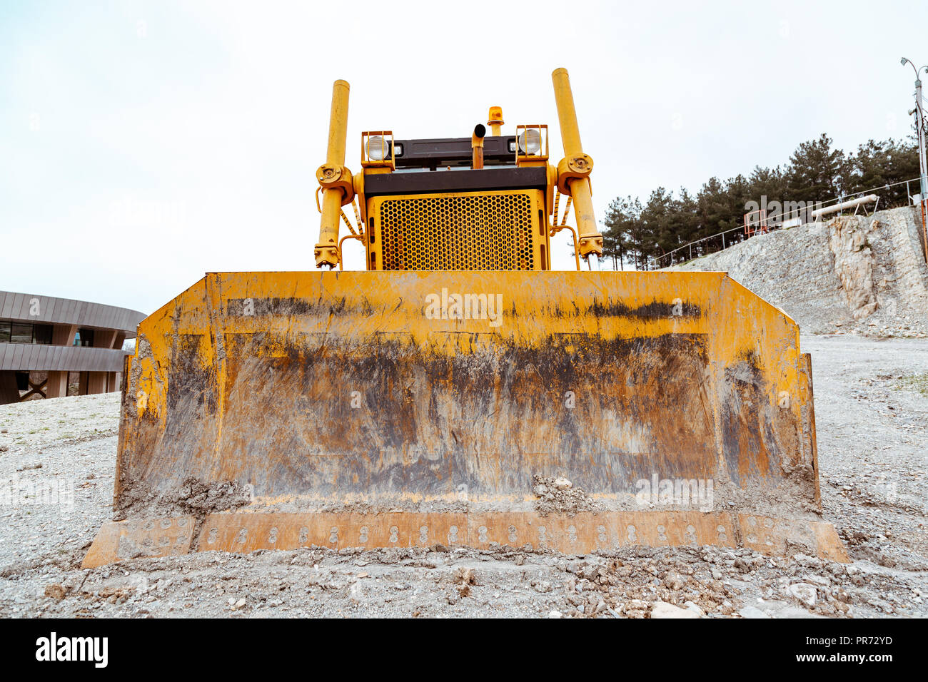 Yellow excavator during work. Close-up front view Stock Photo - Alamy