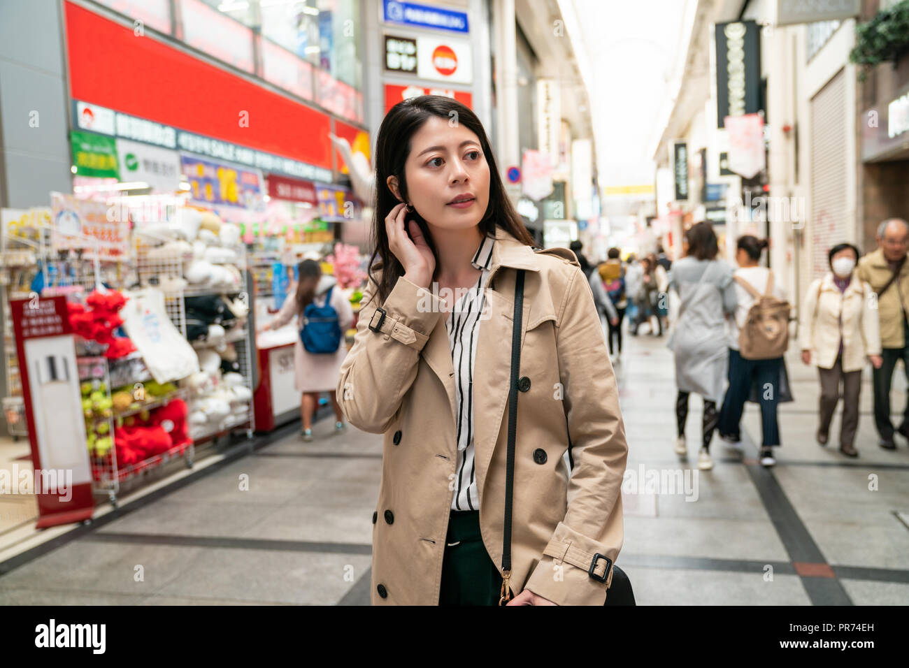 elegant woman flicking her hair and thinking about where to go Stock ...