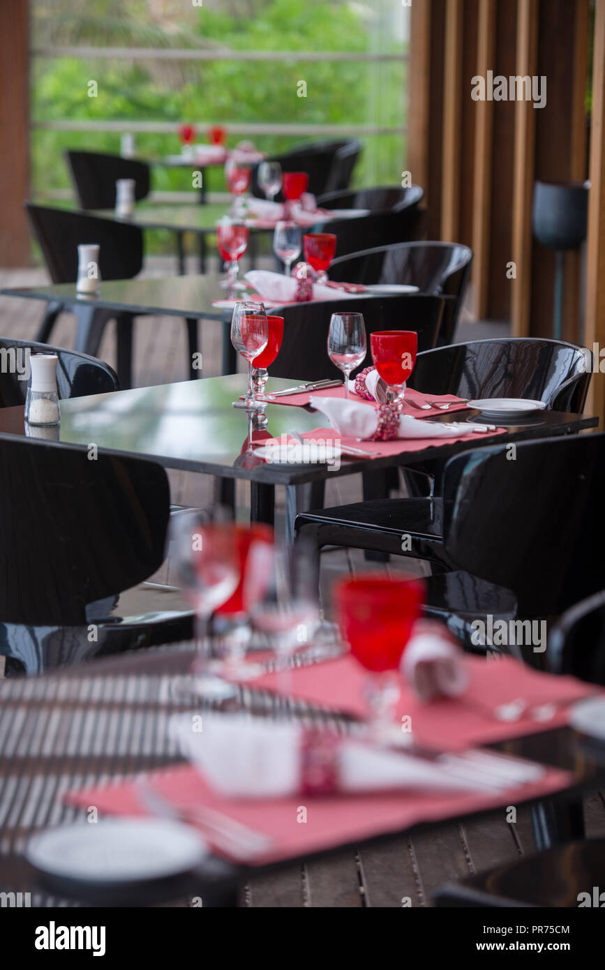 table setting at modern tropical restaurant Stock Photo - Alamy