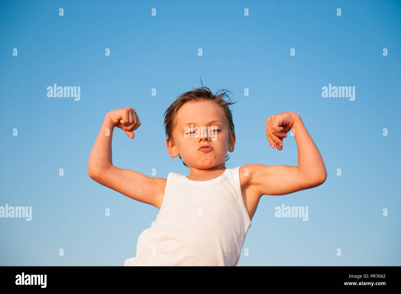 strong healthy little caucasian boy in shirt showing his muscles on ...