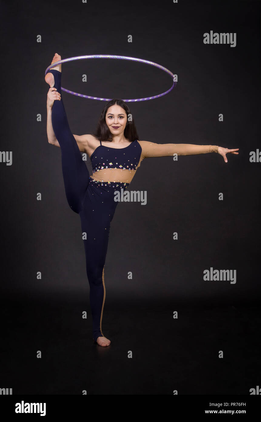 Gymnastic exercises with hula-Hoop woman performs circus performer in ...