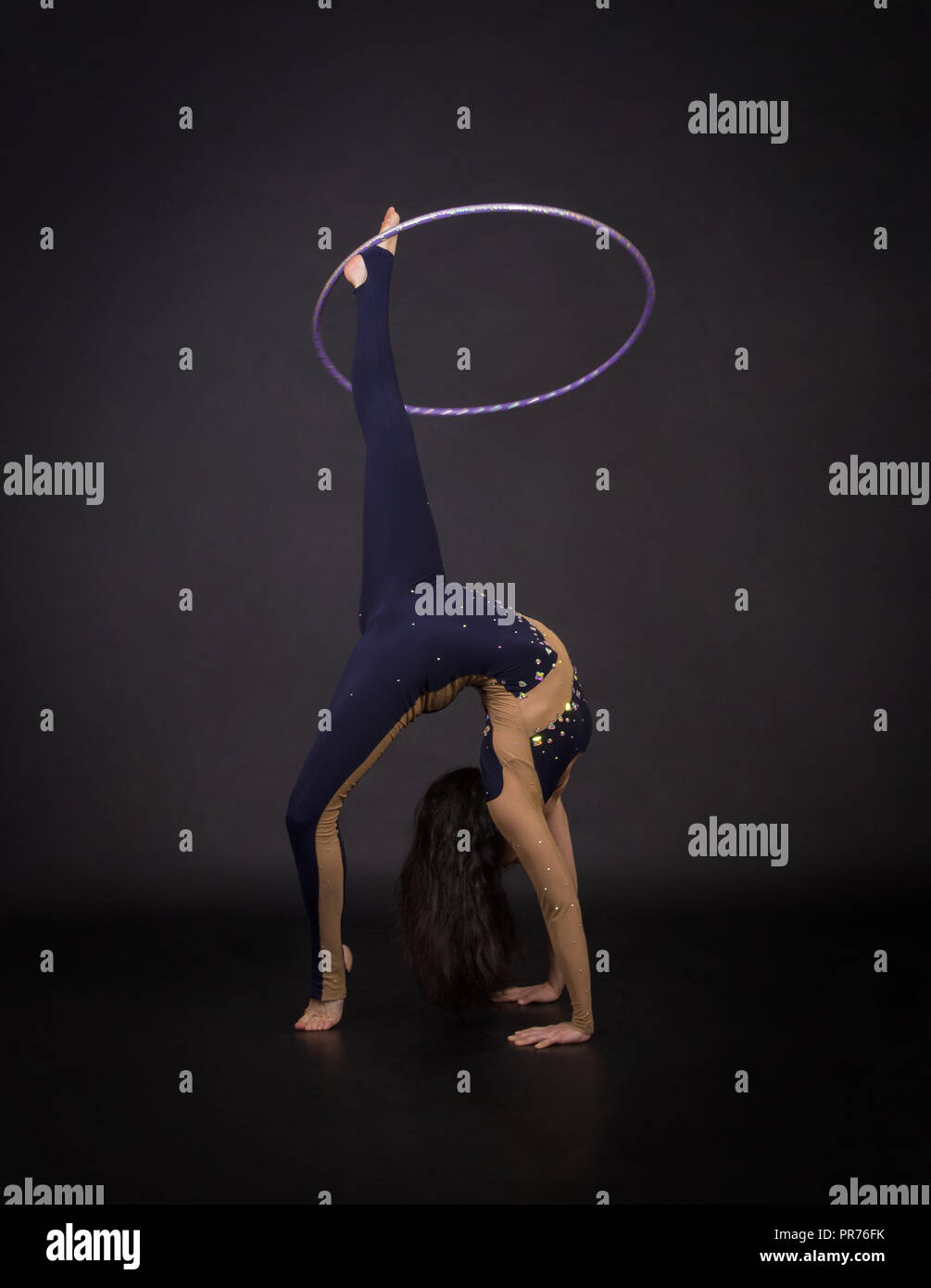 Gymnastic exercises with hula-Hoop woman performs circus performer in ...