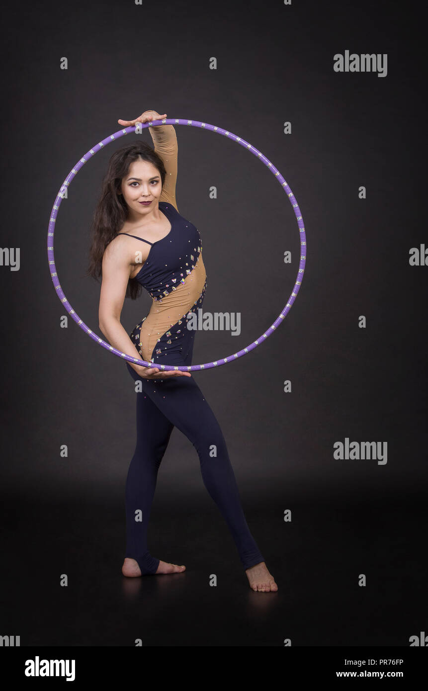 Gymnastic exercises with hula-Hoop woman performs circus performer in ...