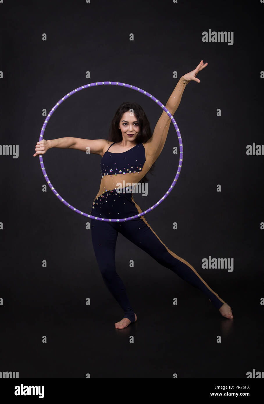Gymnastic exercises with hula-Hoop woman performs circus performer in ...