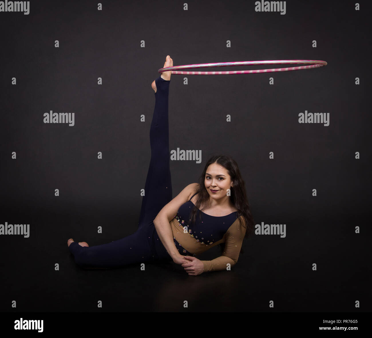 Gymnastic exercises with hula-Hoop woman performs circus performer in ...