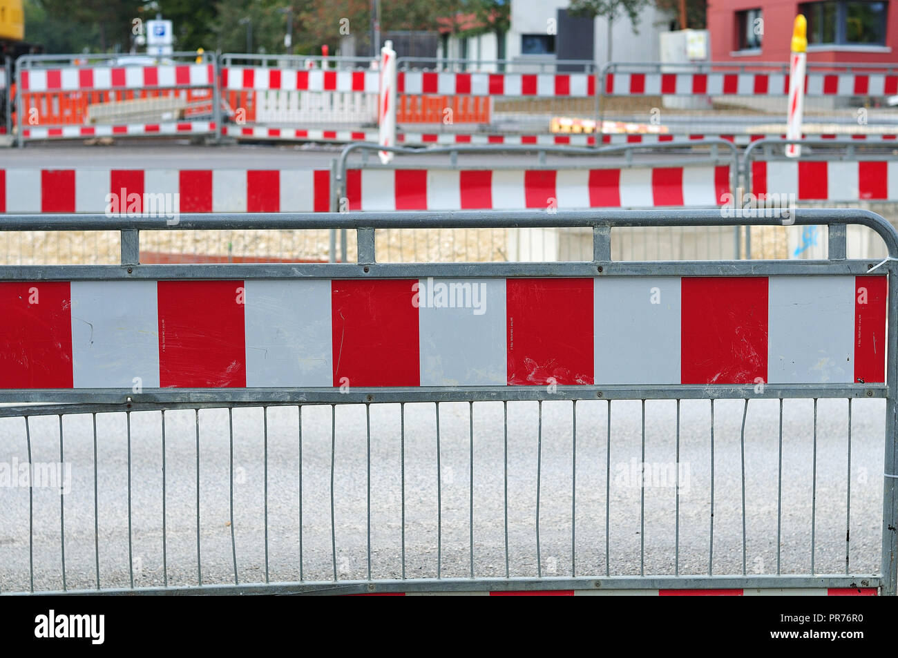 temporary fencing with metal safety barriers at construction site with ...