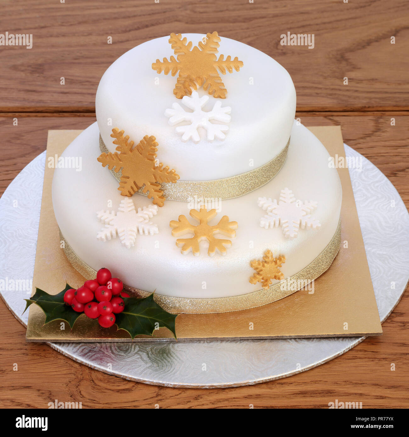 Christmas cake with snowflake decorations on two tiered iced layers ...