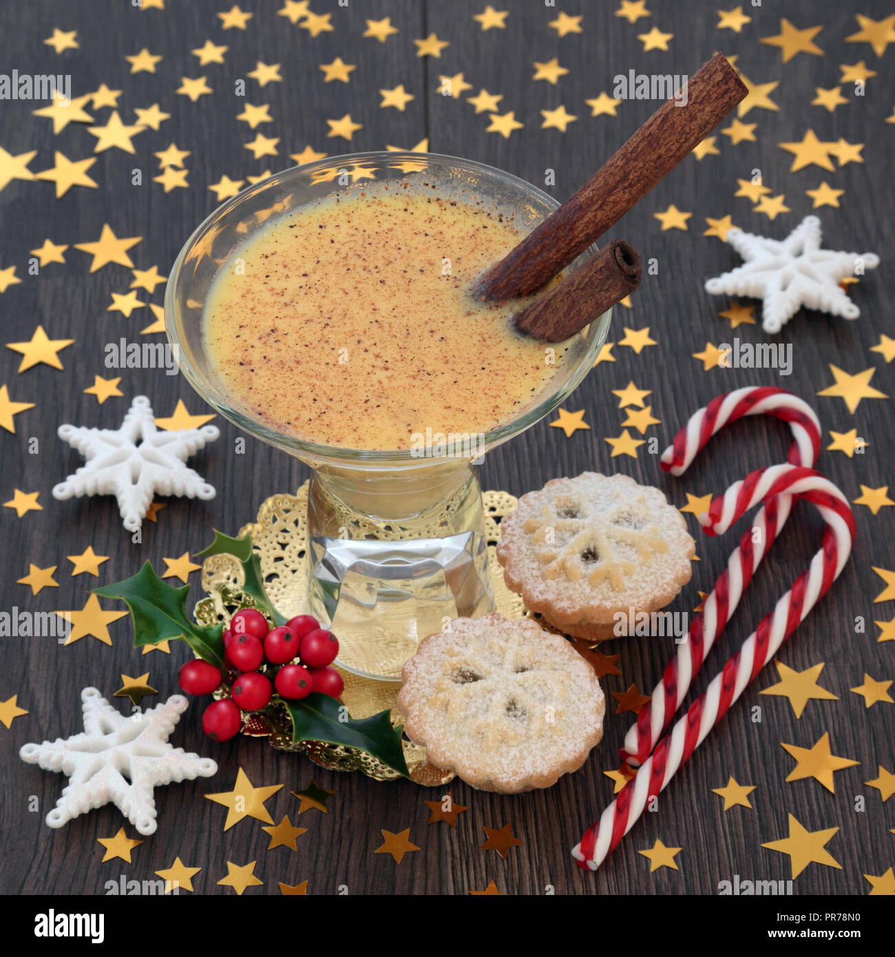 Christmas eggnog traditional drink with mince pies, candy canes, star ...