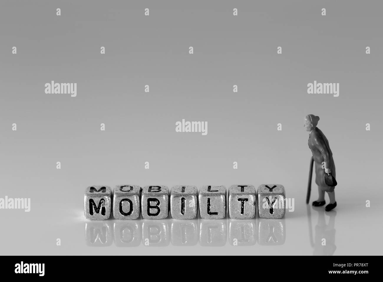 Miniature scale model senior pensioners talking with the word mobility ...