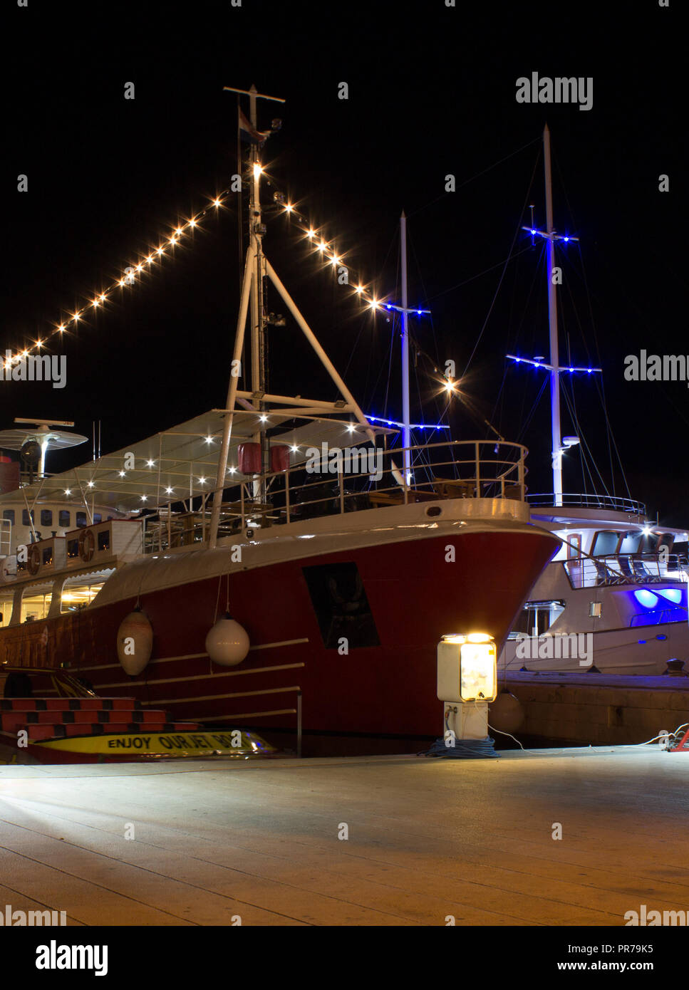 Night view of illuminated ships in port Stock Photo - Alamy