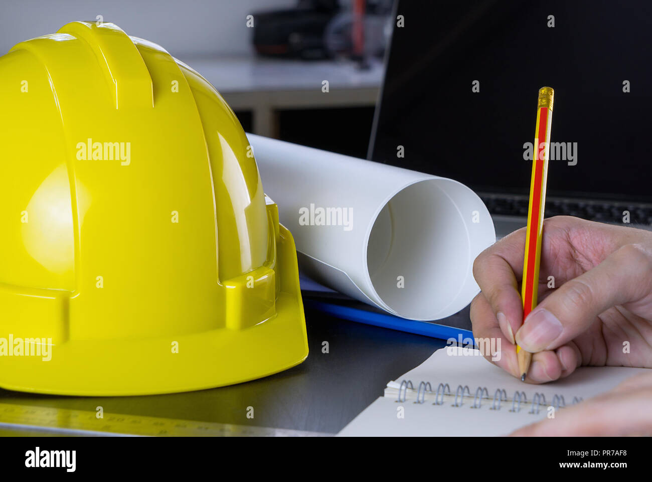Engineer is working on plan and documents Stock Photo - Alamy