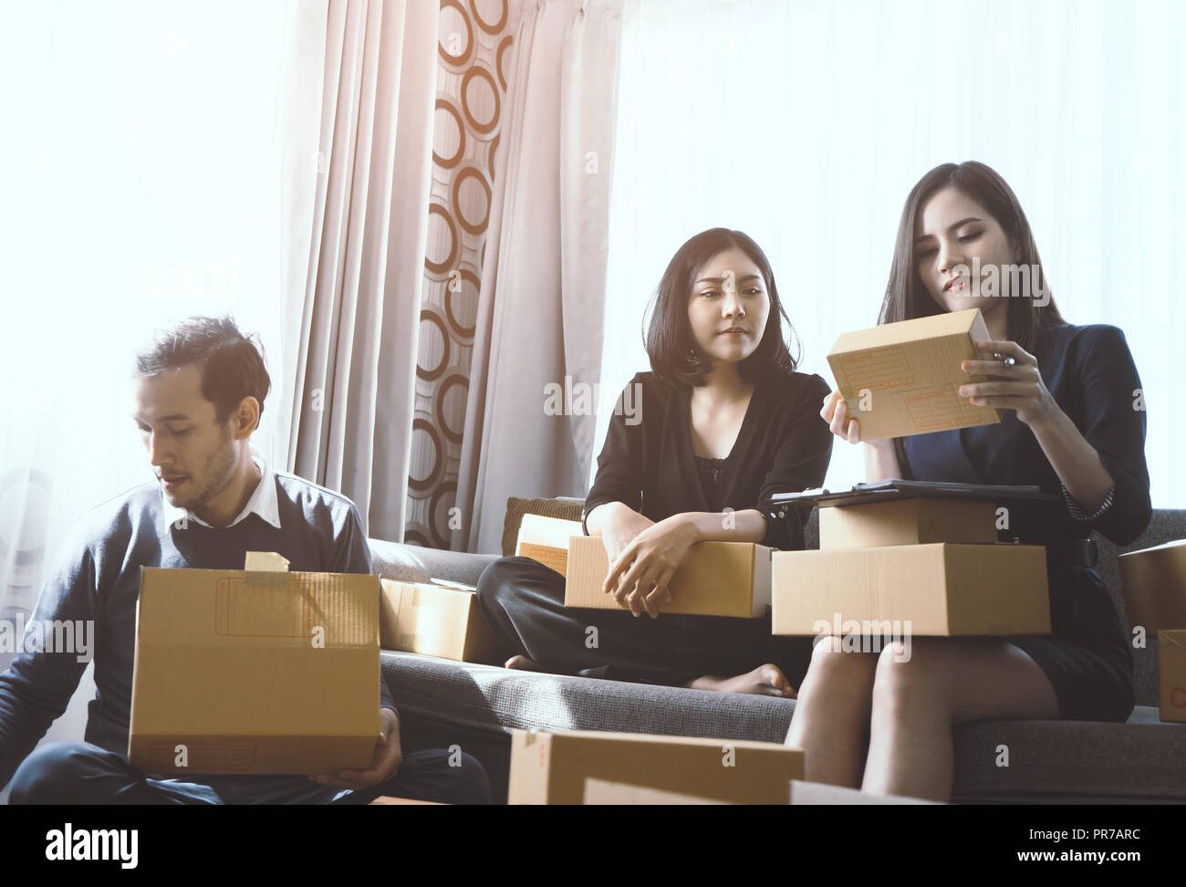 Online business team is packing orders for customer Stock Photo - Alamy